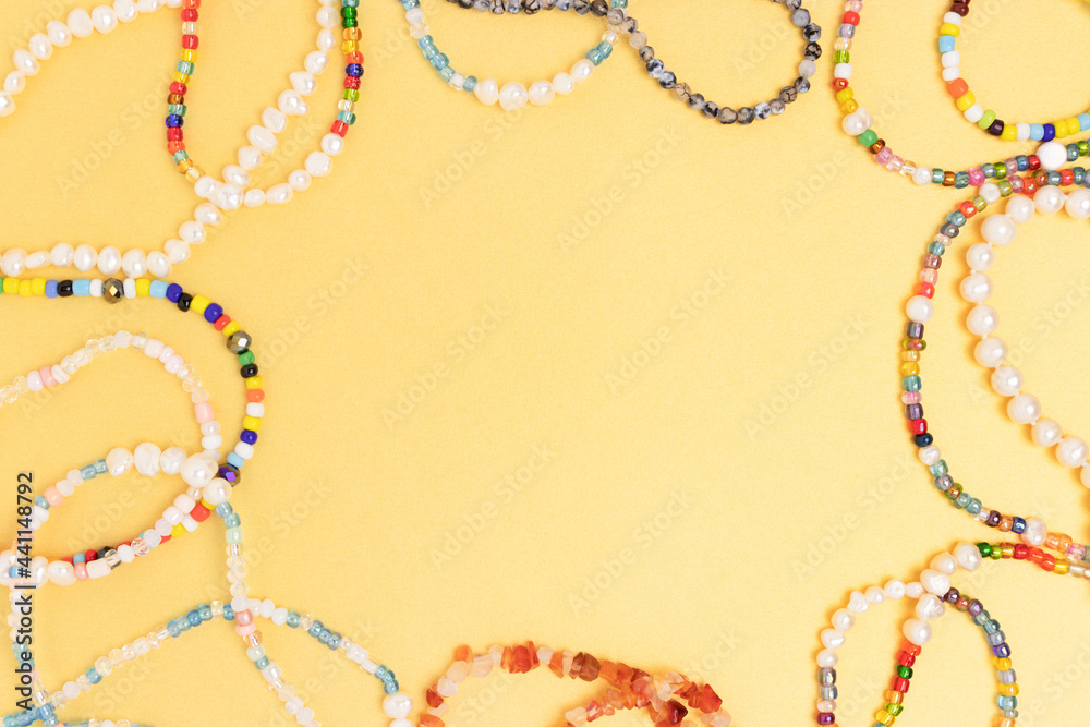 Necklaces and bracelets made from beads and pearls on a golden ...