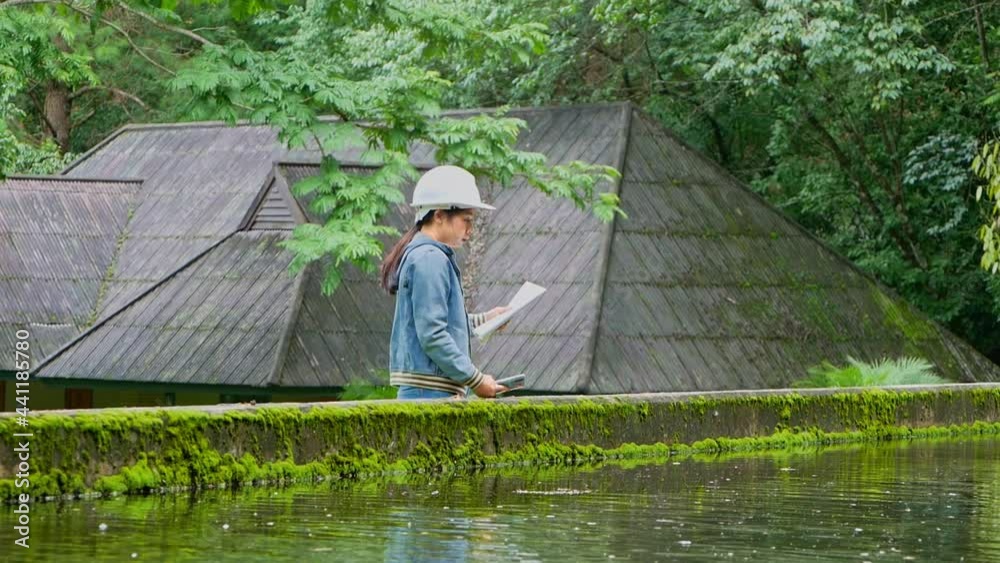 Stockvideo Female ecologist in safety hat working and controlling a ...