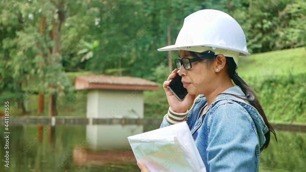 Female ecologist in safety hat working and controlling a quality of ...