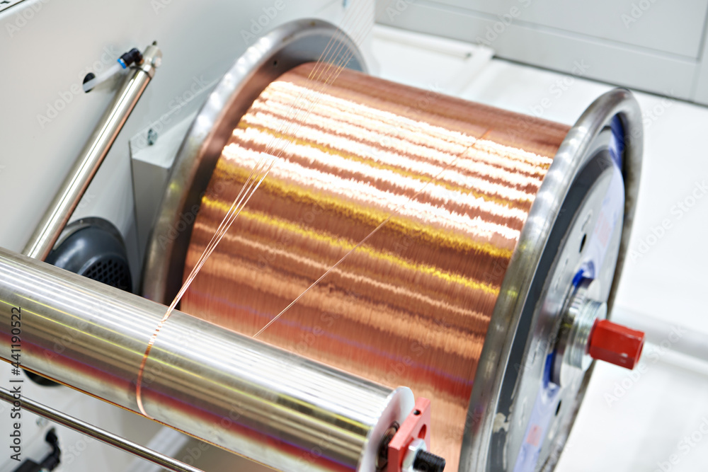Spool of copper wire on braiding machine Stock Photo | Adobe Stock