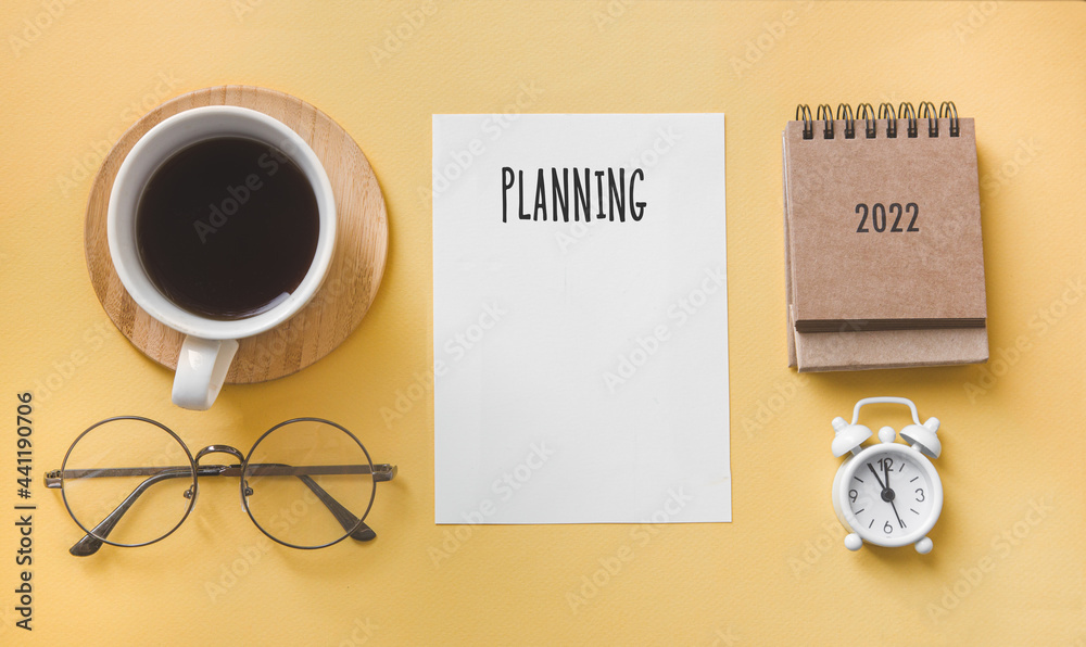 plan for 2022. Calendar and office accessories on the table top view ...