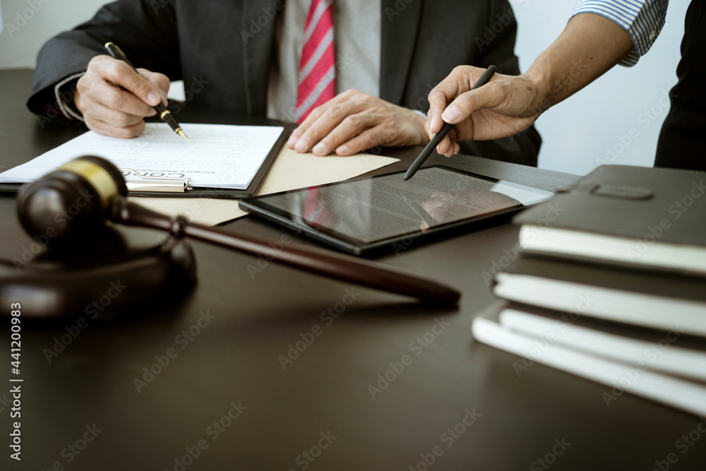 The lawyer is write drafting a legal document while listening to the ...