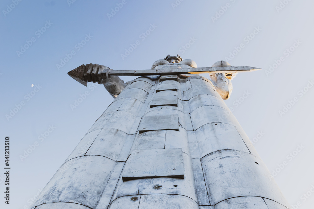 Giant statue of woman holding sword. Mother of Georgia from low angle ...
