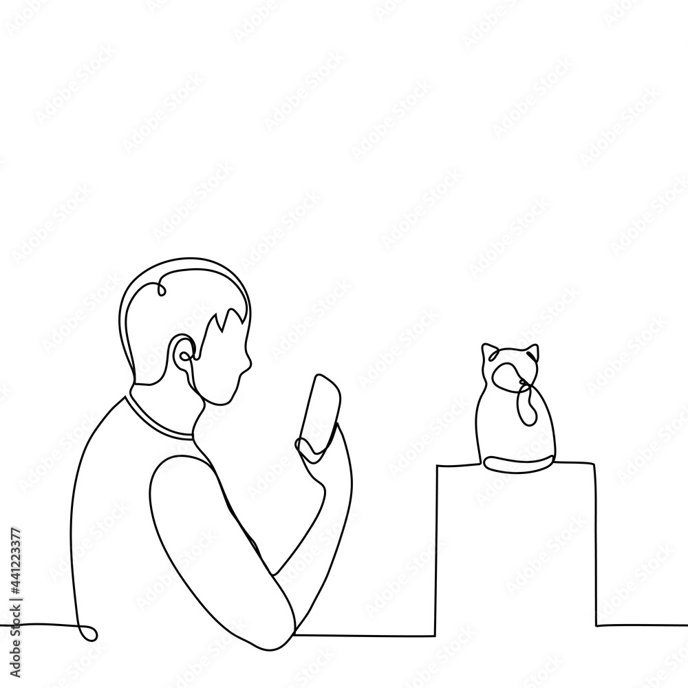 man photographs his cat on the phone, which is licking its paw - one ...