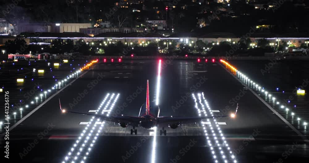 Airport at night 4K, Back view of airplane landing on runway signal ...