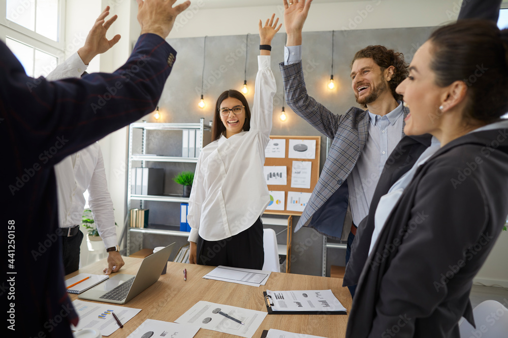 Happy business team celebrating successful completion of project. Group ...