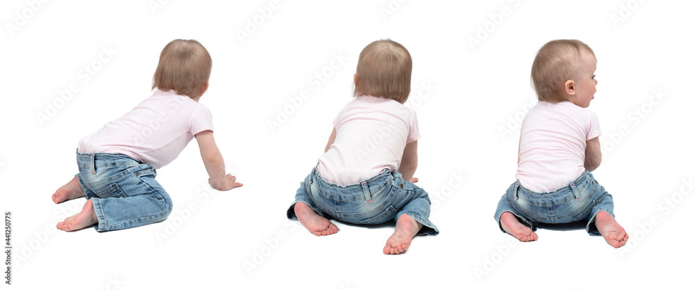 A one-year-old child with his back to the camera, with blond hair ...