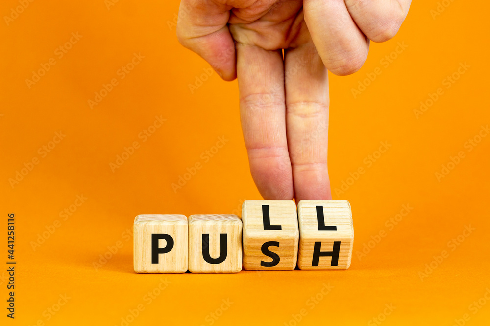 Pull or push symbol. Businessman turns wooden cubes and changes the ...