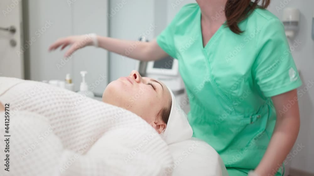 Professional Female Beautician Makes A Face Rejuvenation And Cleansing