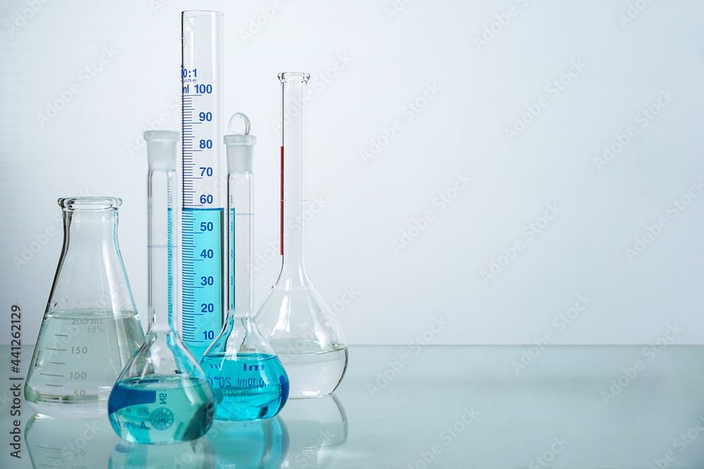 Set of laboratory glassware (beaker) filled different color liquid with ...