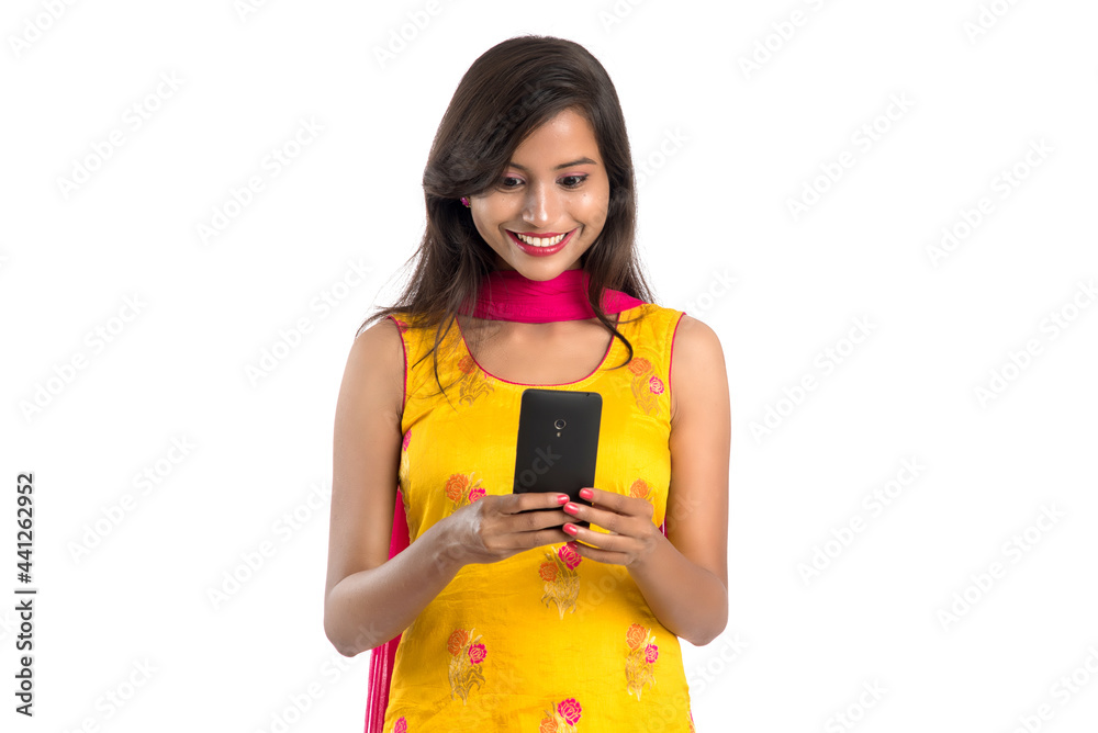 Young Indian girl using a mobile phone or smartphone isolated on a ...