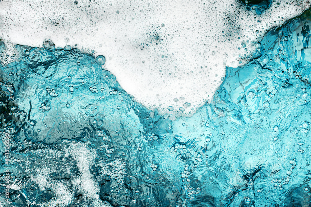 White foam clear blue water background closeup, sea or ocean foam wave ...