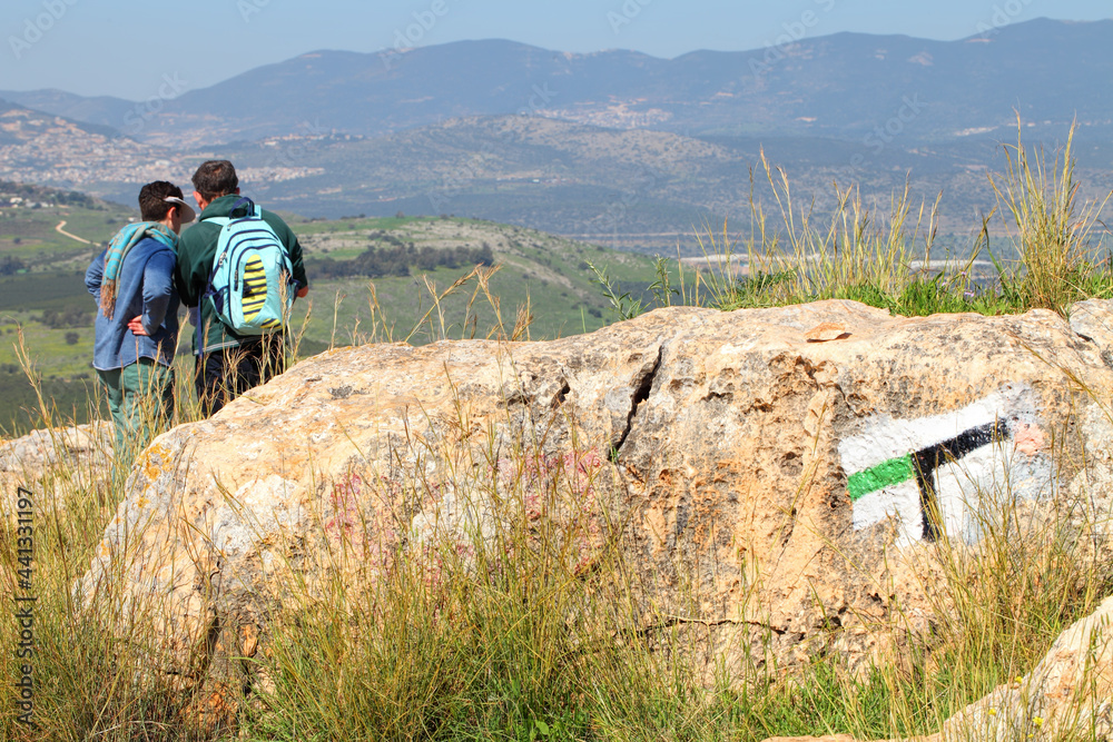 Mount Arbel touristic stony route for hiking. Man and woman travelers ...