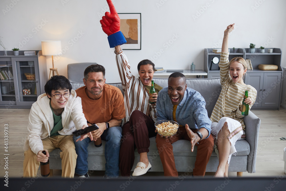 Multi-ethnic group of sports fans watching game match at home and ...