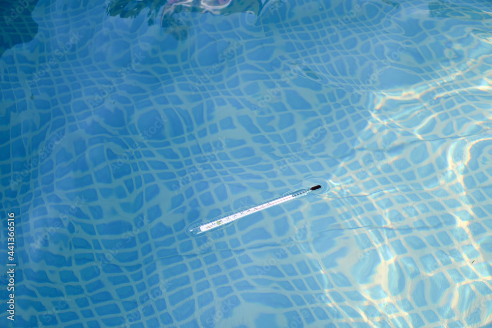 In an outdoor inflatable pool with blue transparent water, a ...