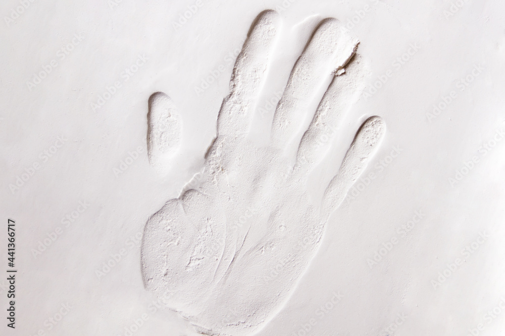 Handprint printed on white flour, sand, powder, dough. Baking, cooking ...