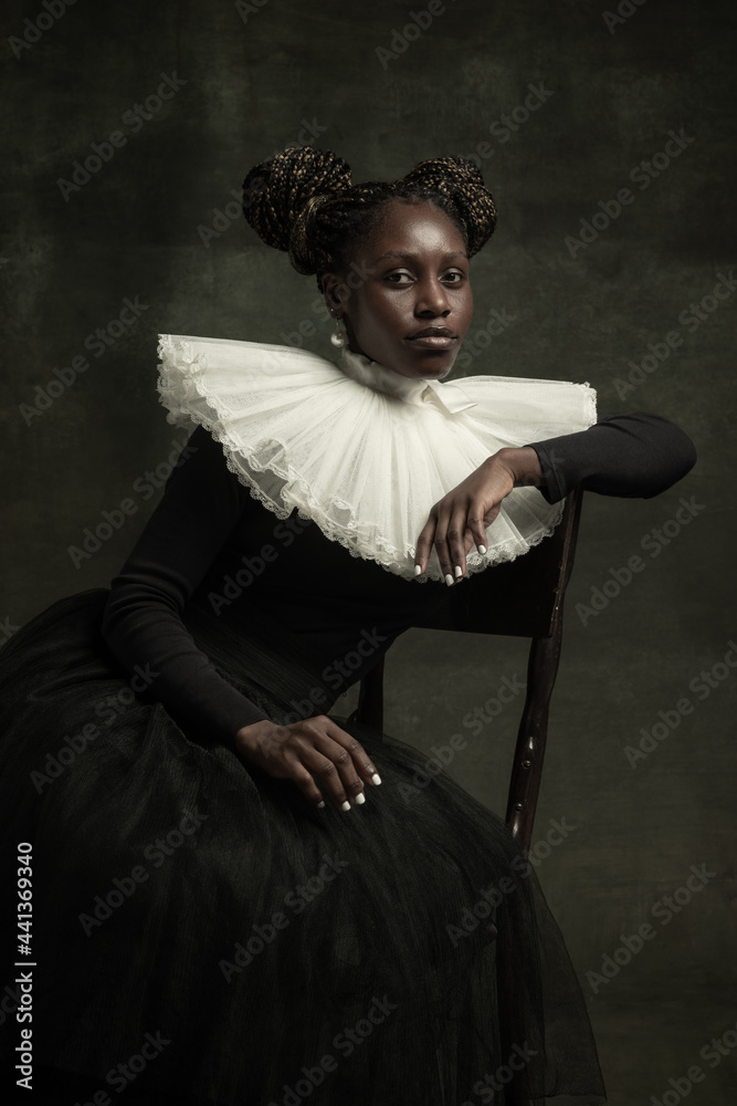Portrait of medieval African young woman in black vintage dress with ...