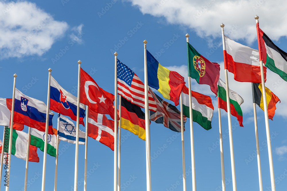 Flags of various states waving in the wind against the background of ...