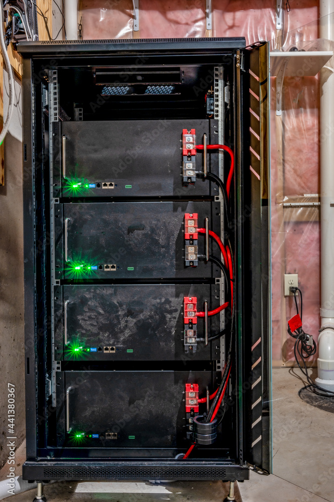 bank of electric batteries in a residential house used for backup power ...
