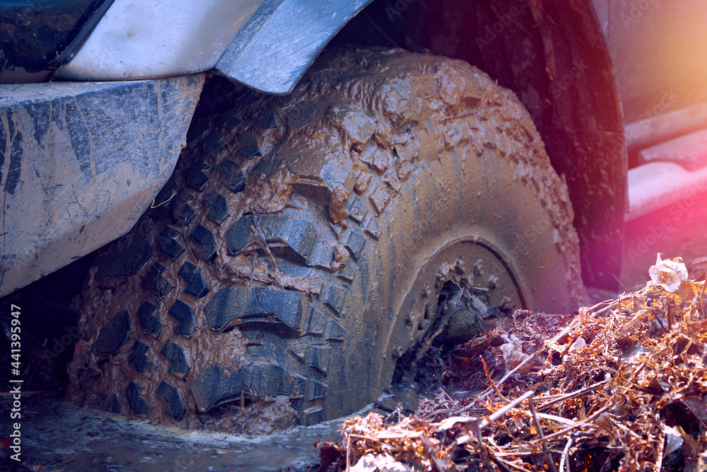 The 4x4 off-road car is stuck in the mud. The wheels of the SUV are in ...
