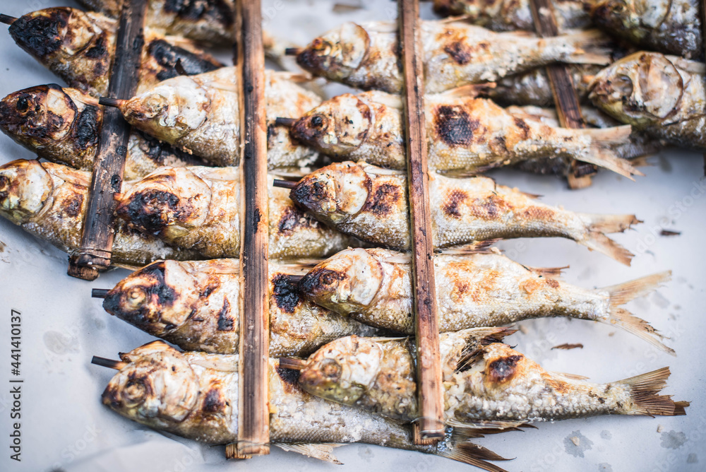 Freshwater fish wrapped in bamboo and grilled with wooden shavings are ...