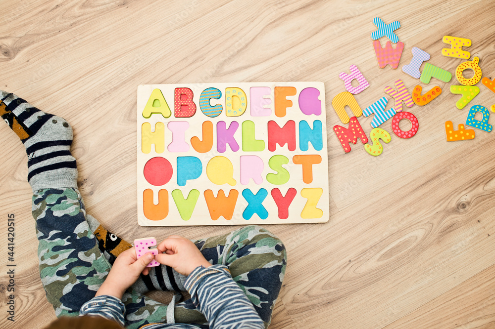Baby early learning. Wooden letters of the alphabet. Children reading ...