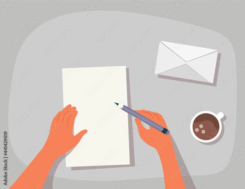 Hands are holding a pencil and writing a letter. Top view of the table ...