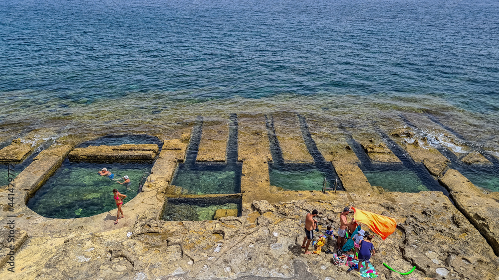 Fond Ghadir Beach,, Sliema, Malta - June 20th 2021: Man made rock pools ...