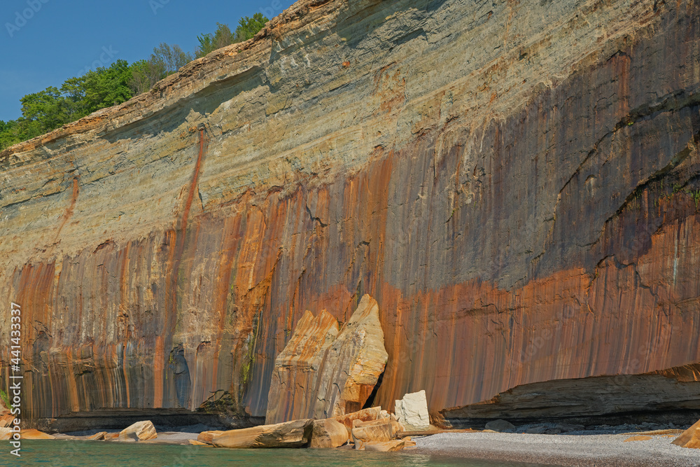 Landscape of the mineral stained, sandstone and eroded shoreline of ...