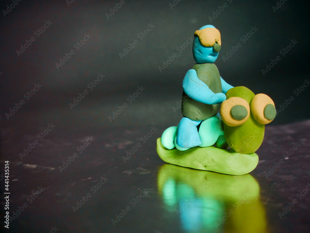 Clay man seating upon cartoon creature isolate on grey frame Stock ...