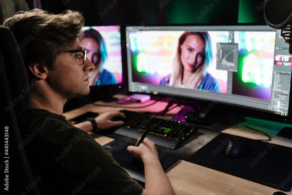 Back view of a young white man video editor Stock Photo | Adobe Stock