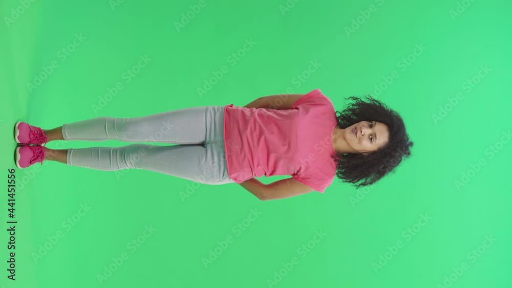 Portrait of young female African American nods head and points not to ...