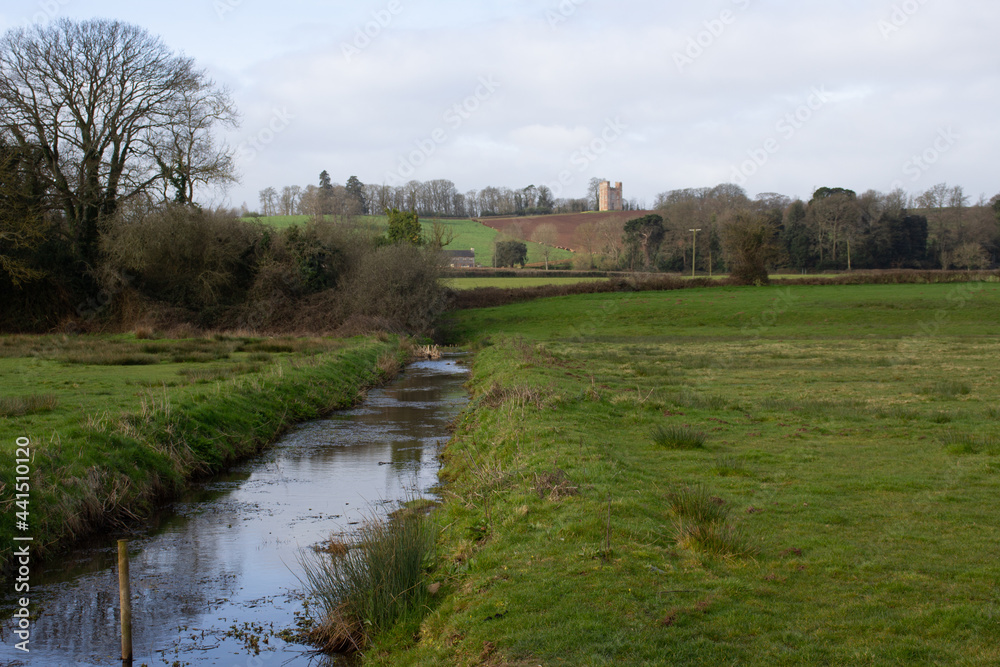 drainage channel in typical English farmland with Folly in the distance ...