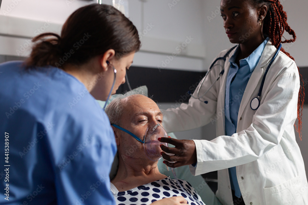 Side view of senior patient breathing assisted by respiratory tube in ...