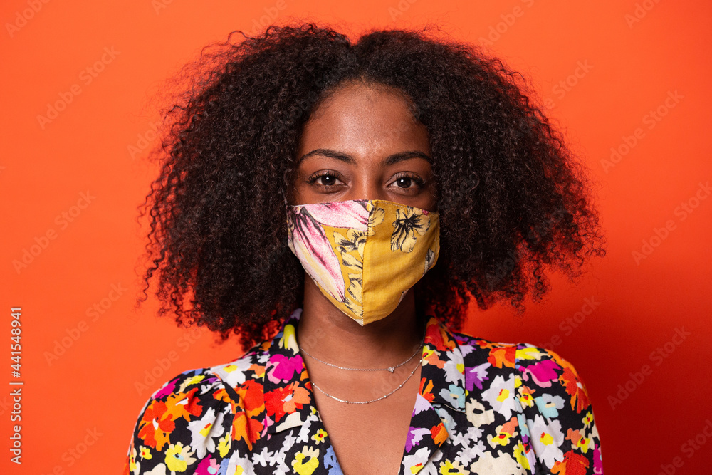 Stylish black woman wearing on face mask Stock Photo | Adobe Stock