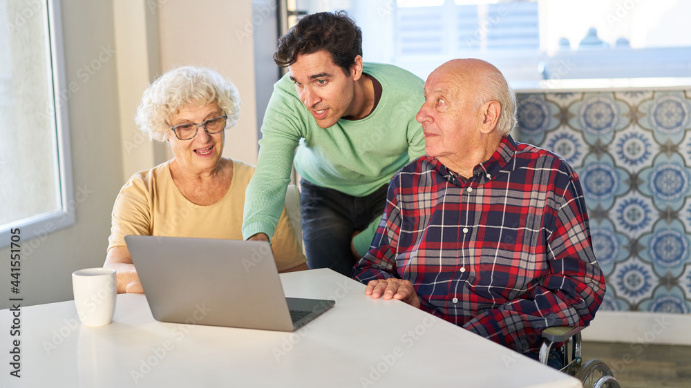 Young man helping senior couple on laptop computer Stock Photo | Adobe ...