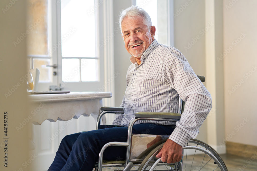 Senior sitting in wheelchair at home smiling Stock Photo | Adobe Stock