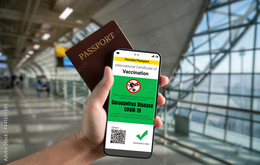 Traveler holds vaccine passport certificate to show COVID 19 ...