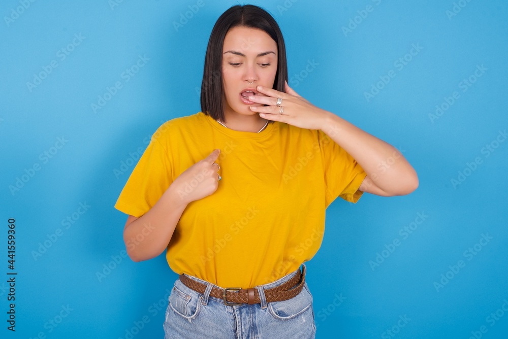 Shocked young beautiful brunette girl with short hair standing against ...