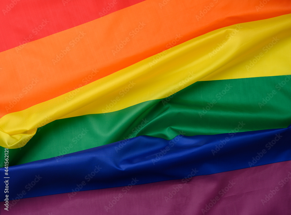 textile rainbow flag with waves, symbol of freedom of choice of ...