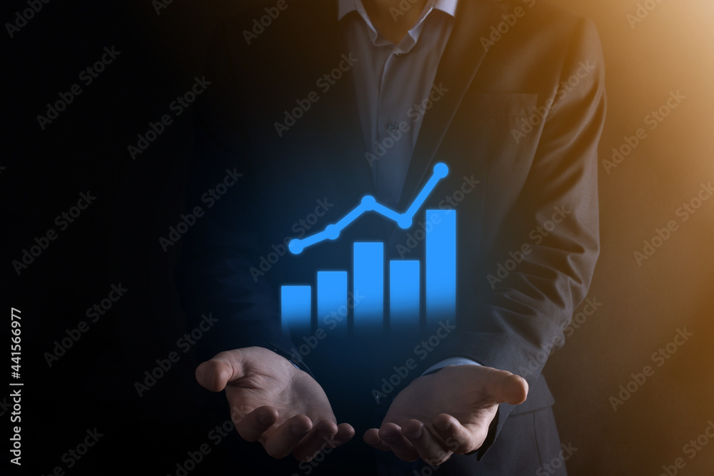 Businessman man holding a graph with positive profits growth. plan ...