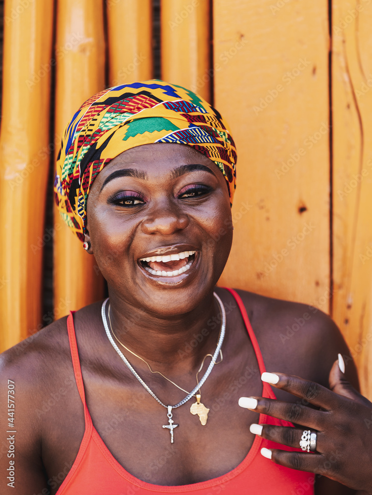 African woman with a hopeful happy smile and traditional headdress ...