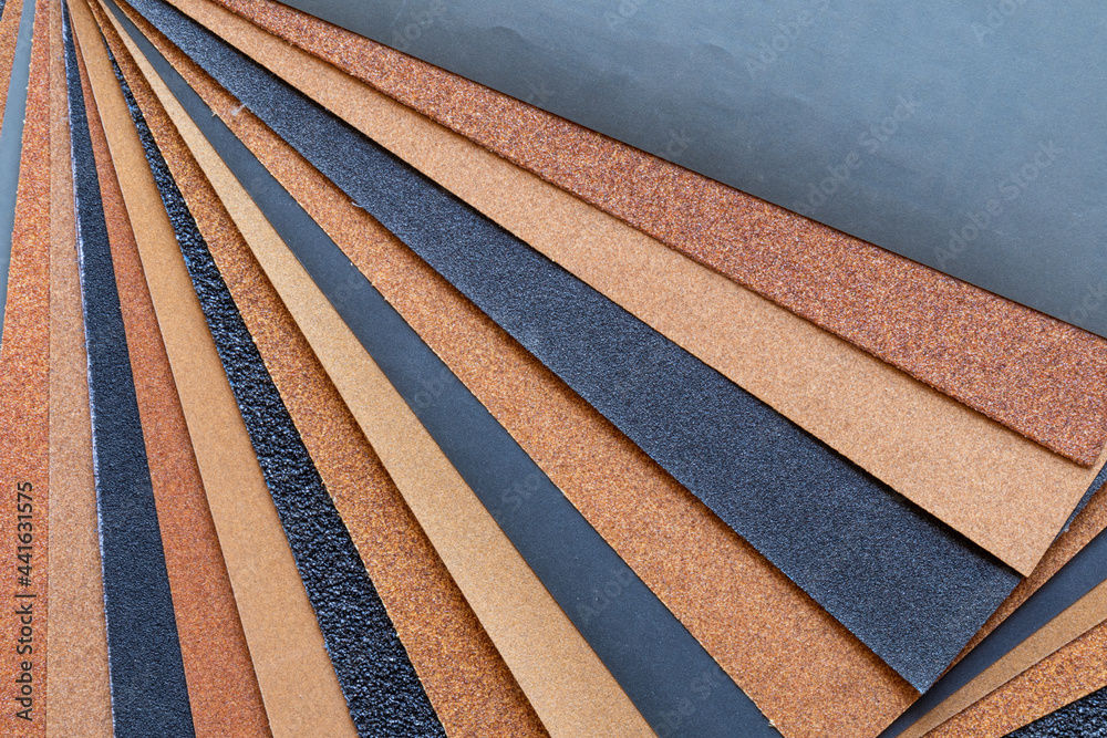 The background of the sandpaper surface, where the grains of sand on ...