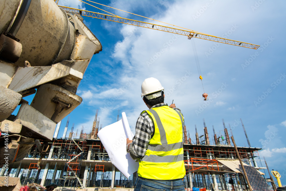 Civil engineer checking work with walkie-talkie for communication to ...