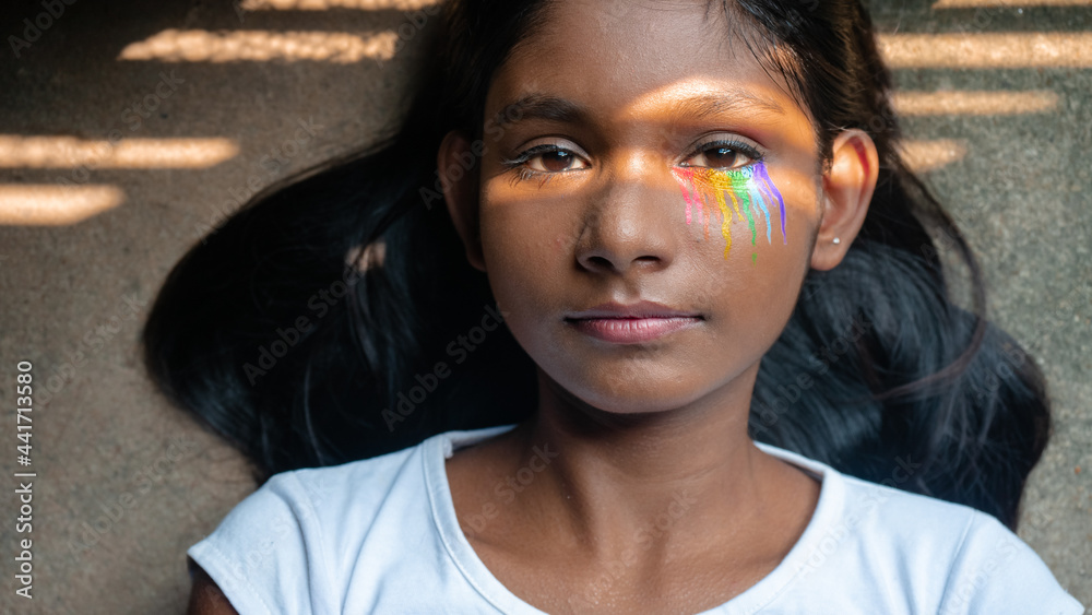 Close-up portrait of a young girl of LGBTQ community staring intensely ...