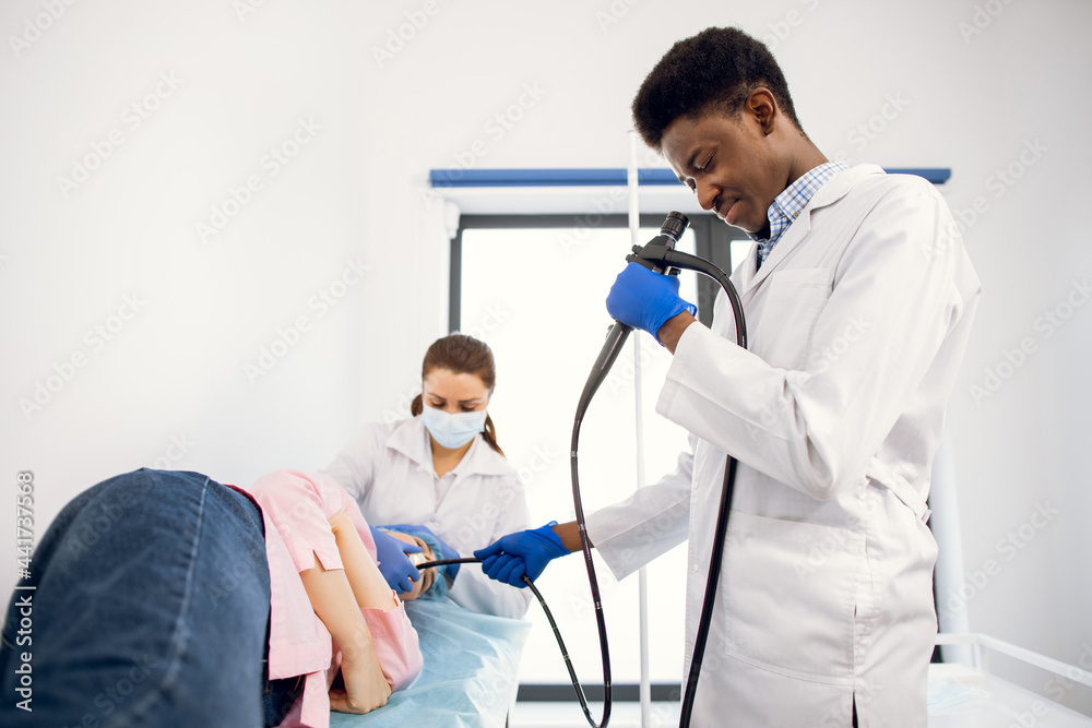 Young african american man doctor and female nurse doing endoscopy ...