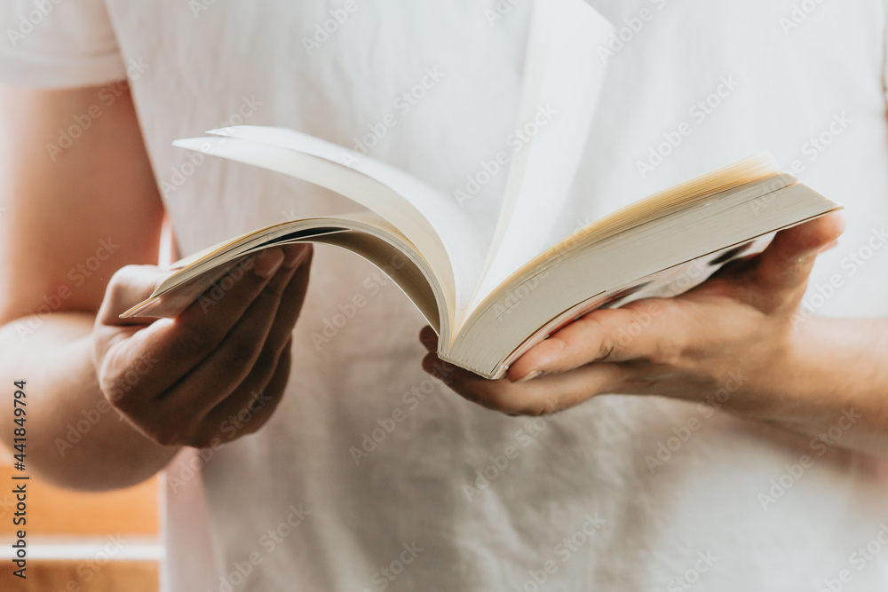 Super close up of two hands grabbing and reading a book during a super ...