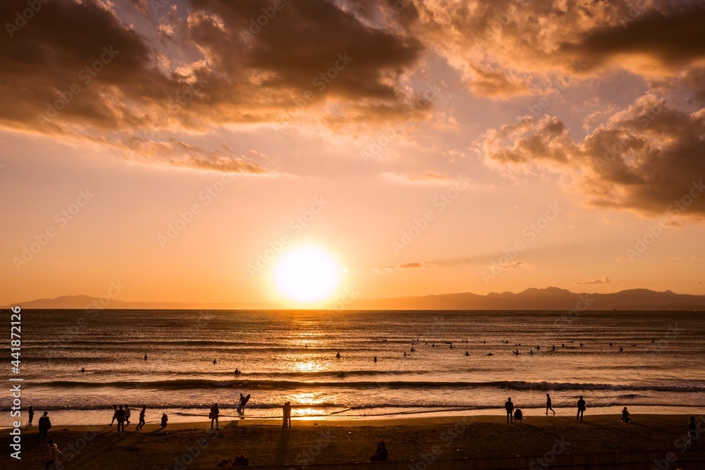 The romantic sunset and beach scene in summer with silhouette of People ...