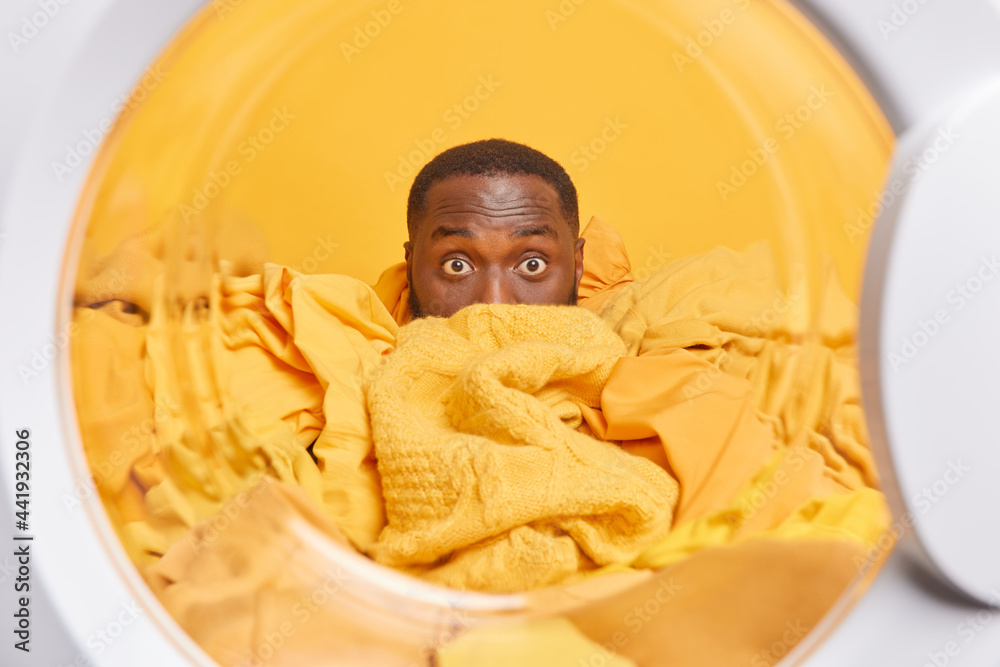 Stunned African American black man with dark skin covered with pile of ...