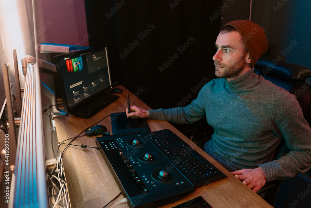 Attractive Male Video Editor Works with Footage or Video on His ...